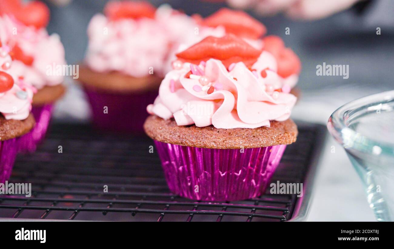 Close up view. Step by step. Decorating red velvet cupcakes with ...