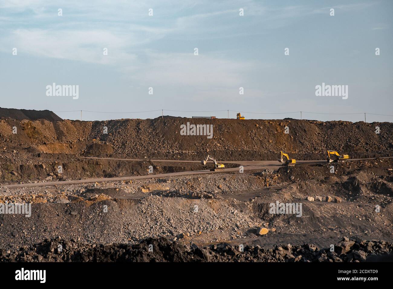 Concept open pit mine industry. Metaphor giraffes excavator moving end ...
