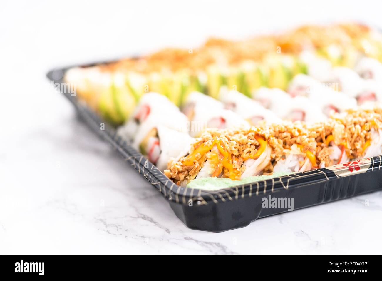 Pre-packaged variety of sushi and sushi rolls in a plastic tray Stock ...