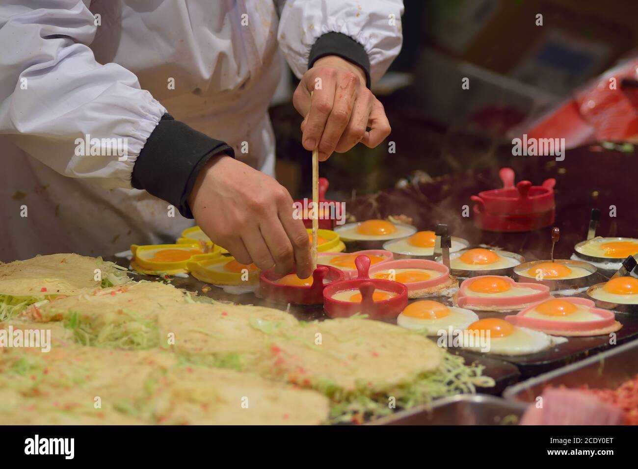 Tokyo street food of Octopus meat balls called Okonomiyaki being ...