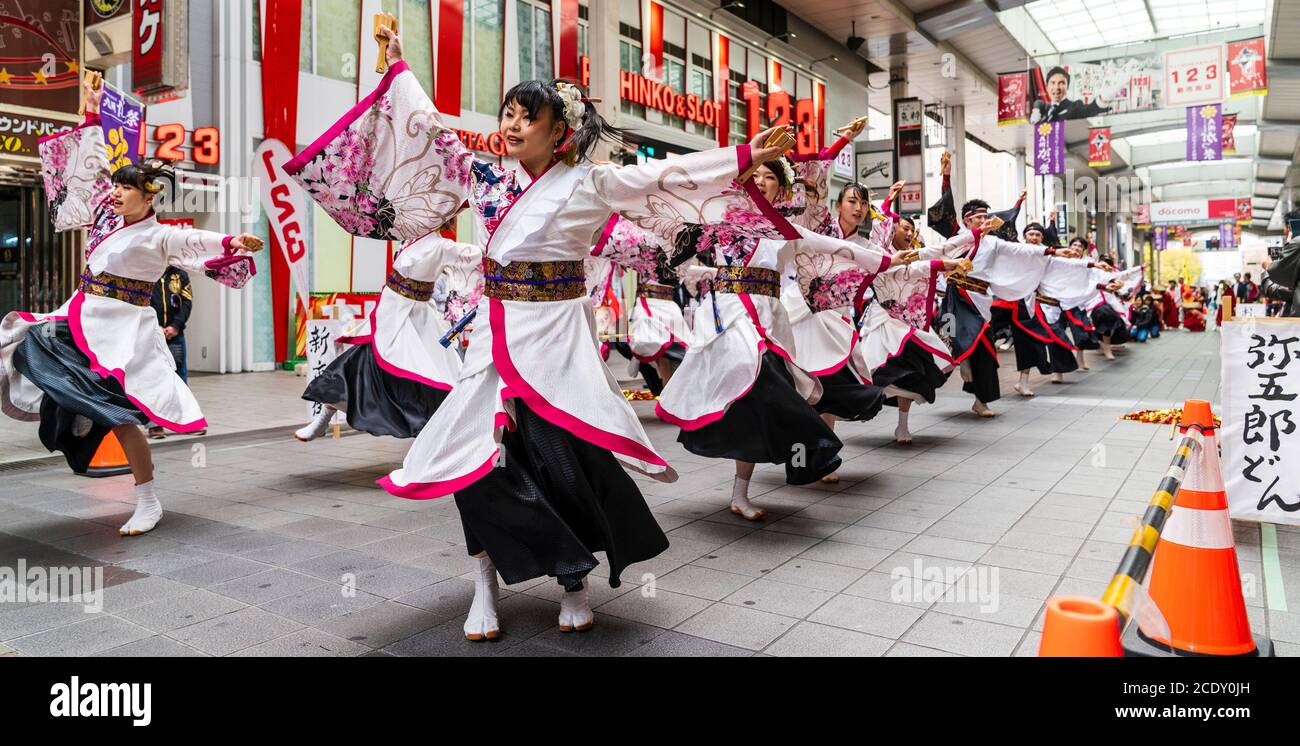 Japanese team of yosakoi dancers wearing long sleeved yukata and using ...