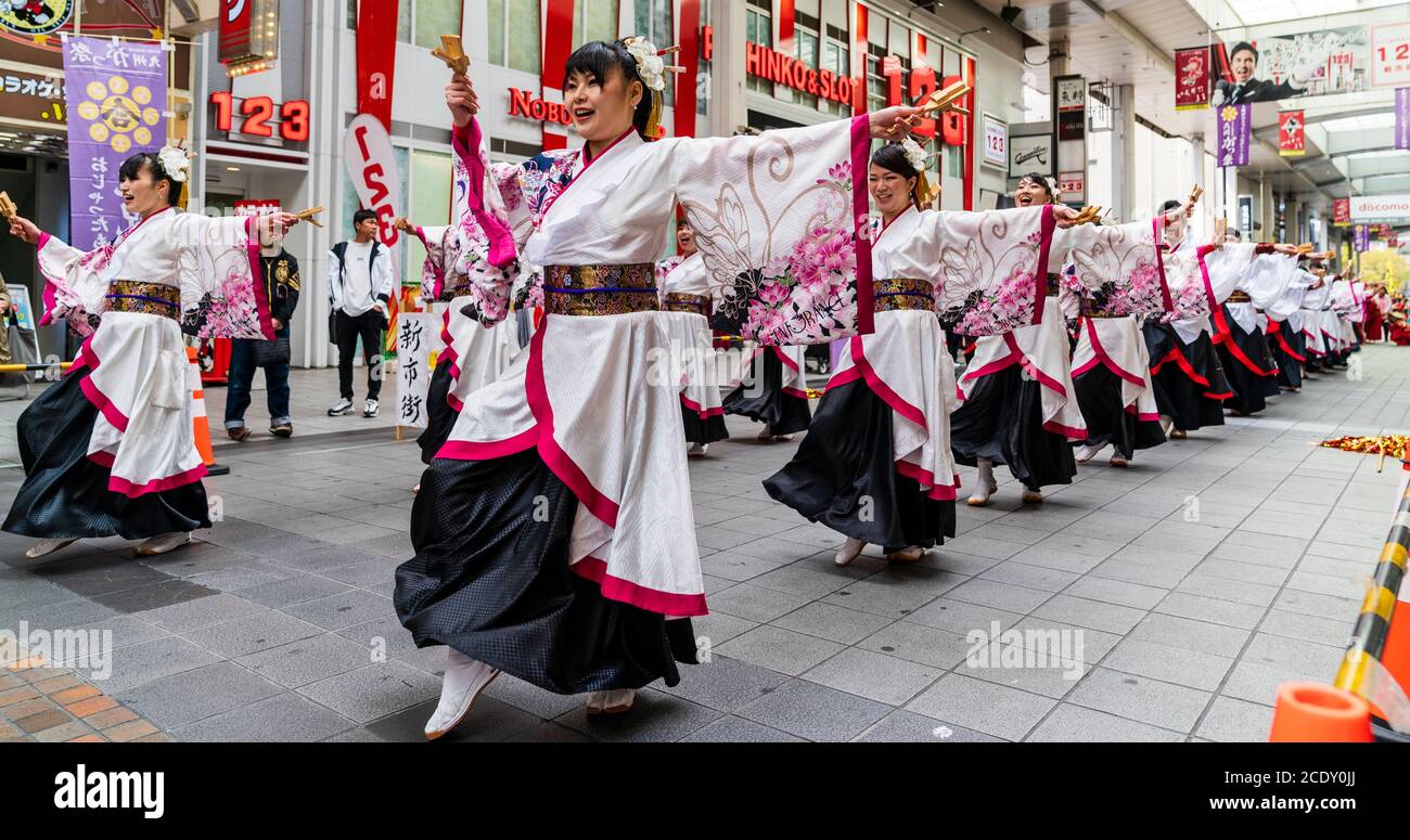 Japanese team of yosakoi dancers wearing long sleeved yukata and using ...
