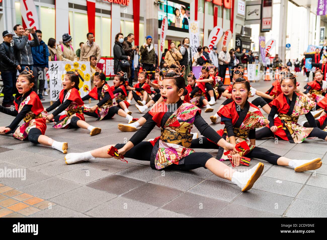 Japanese team of child yosakoi dancers holding naruko, wooden clappers ...
