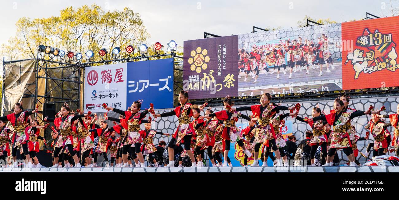 Team of Japanese child yosakoi dancers on stage dancing while using ...