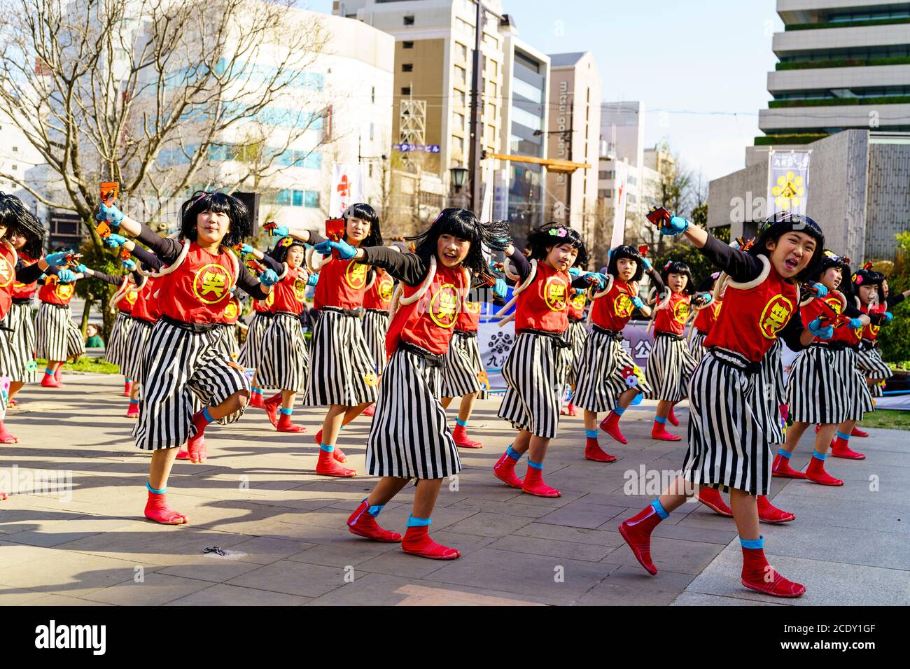 Team of Japanese child yosakoi dancers dancing while using naruko ...
