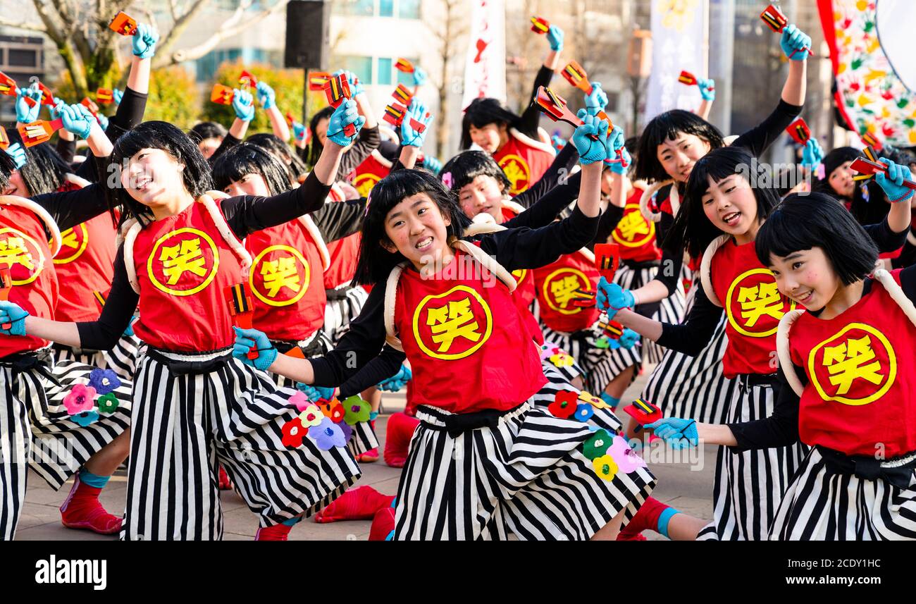 Team of Japanese child yosakoi dancers dancing while using naruko ...