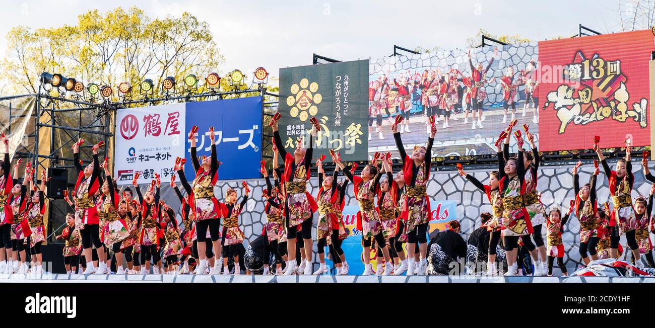 Team of Japanese child yosakoi dancers on stage dancing while using ...