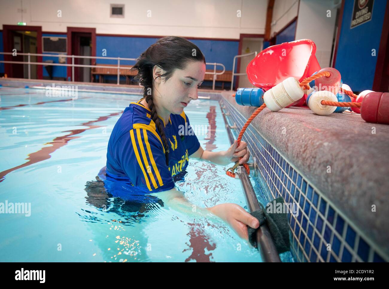Bella Walker cleans the pool rails and perimeter tiles at the Arlington ...