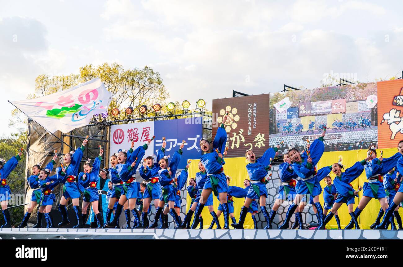 Japanese team of yosakoi children, girl dancers on stage using naruko ...