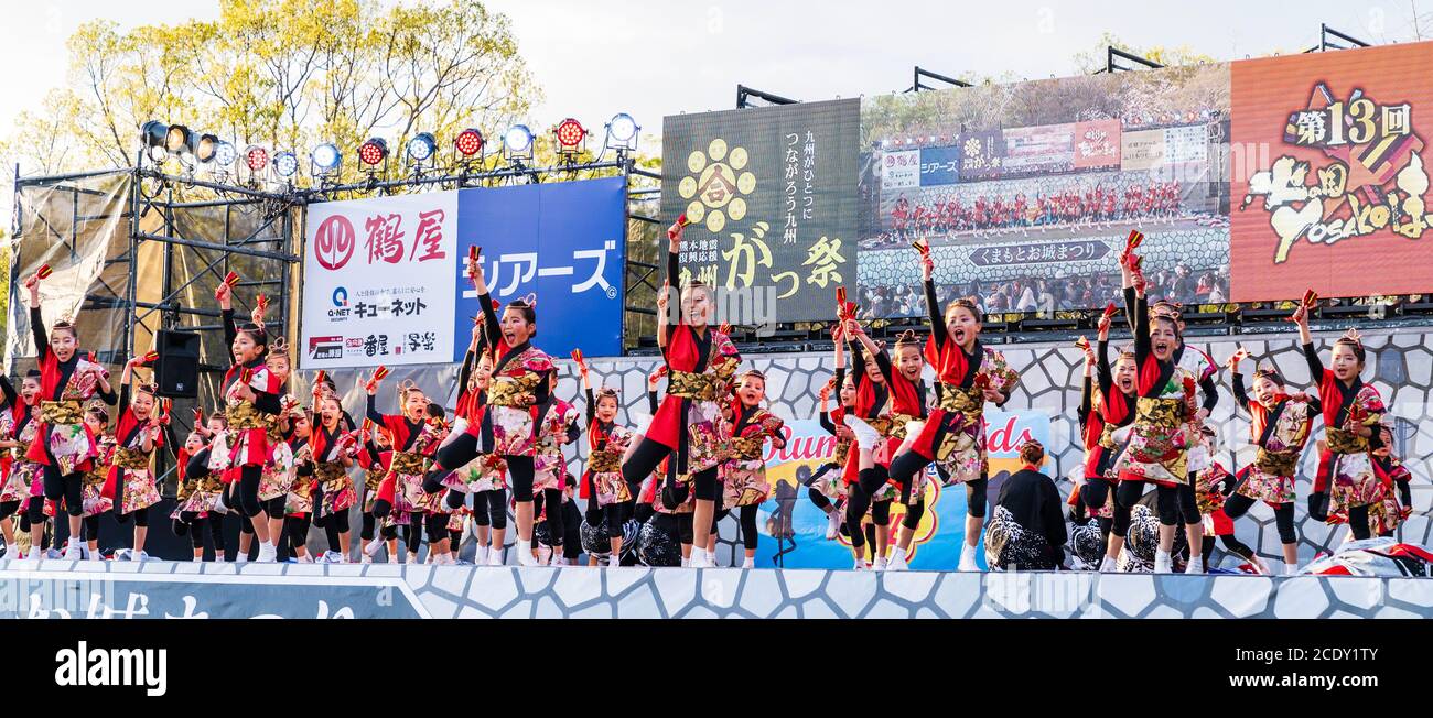 Team of Japanese child yosakoi dancers on stage dancing while using ...