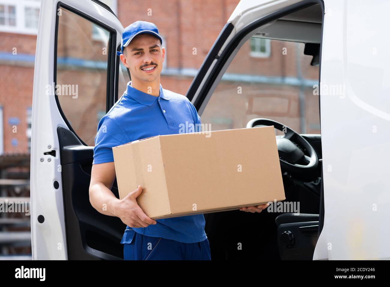 Cardboard Box Delivery Near Van. Commercial Load Stock Photo - Alamy