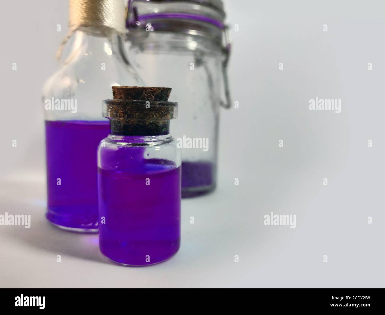 Potions with violet liquid. Alchemy set with flasks. small glass ...