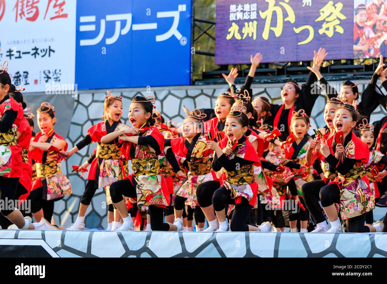 Team of Japanese child yosakoi dancers on stage dancing while using ...
