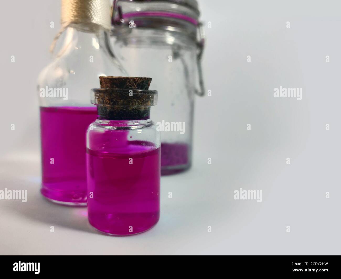 Potions with pink liquid. Alchemy set with flasks. small glass bottles ...