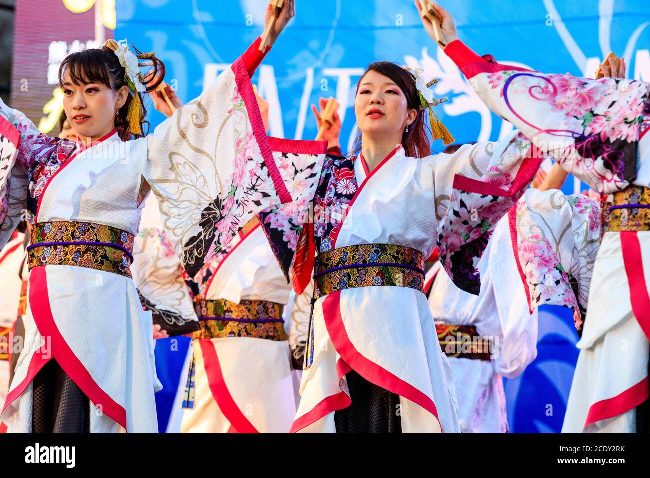 Japanese team of yosakoi women dancers with naruko, wooden clappers, in ...