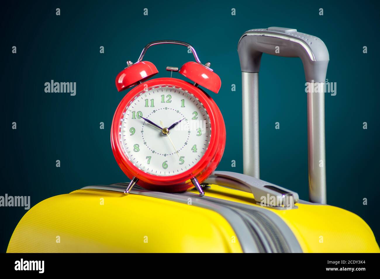Alarm clock on luggage. Travel and holiday concept. Studio shot Stock ...