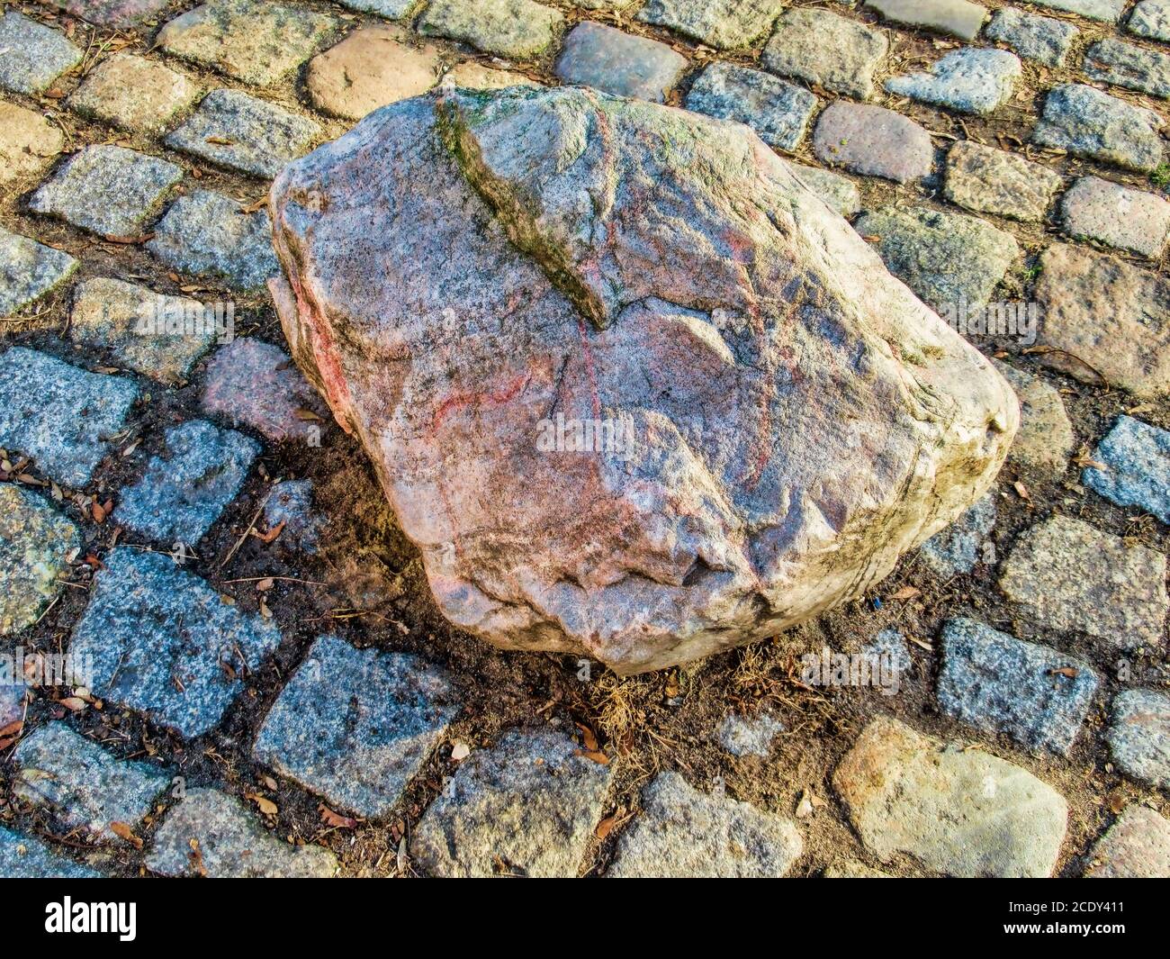 Rocks framed by small paving stones Stock Photo - Alamy