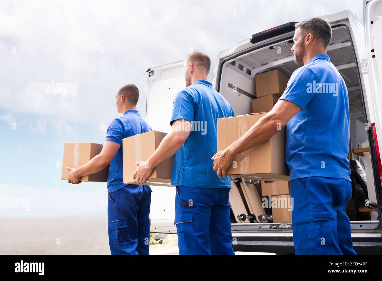 Truck Movers Loading Van Carrying Boxes And Moving House Stock Photo ...