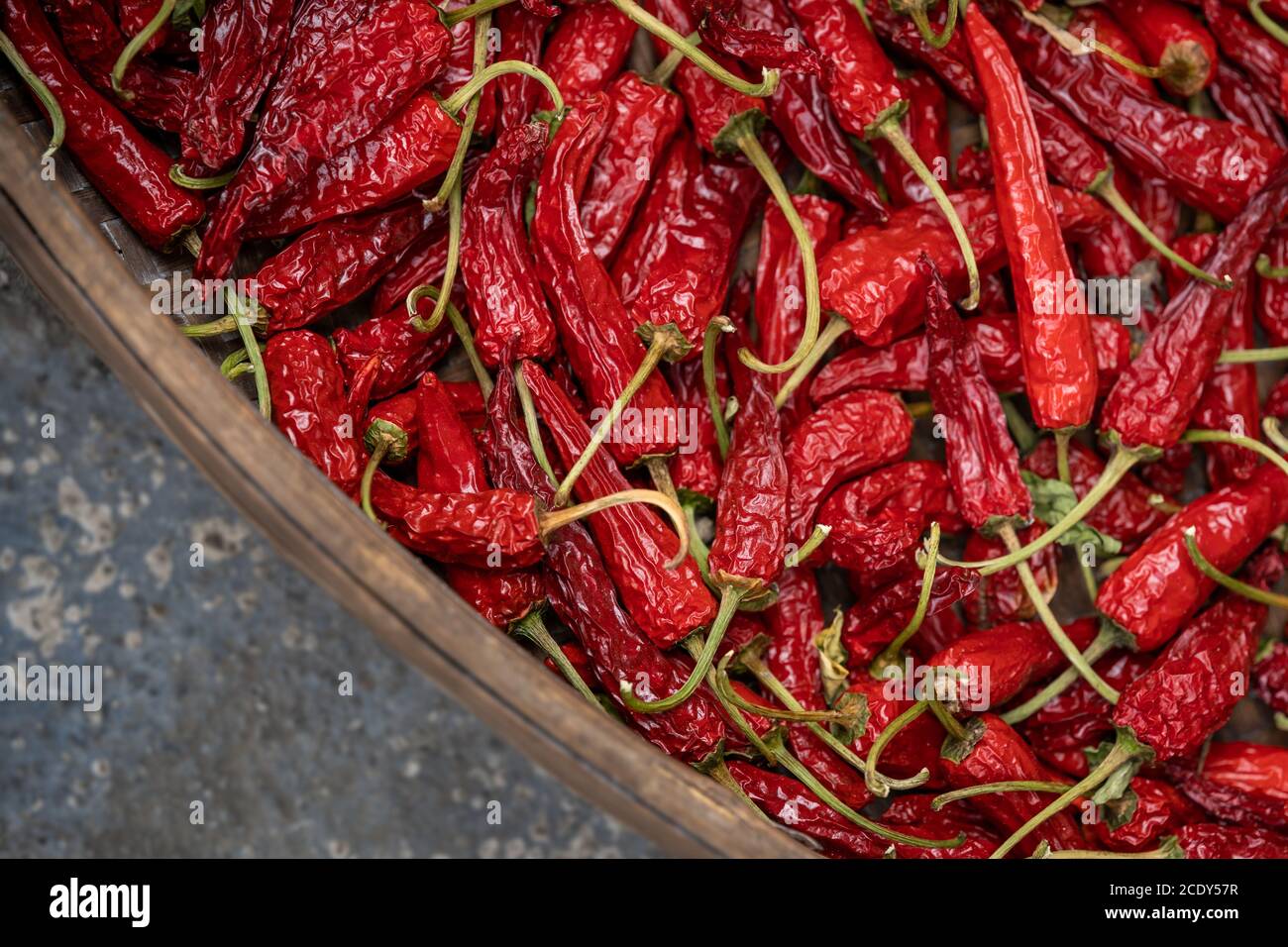 Chili drying in a wicker bowl Stock Photo - Alamy