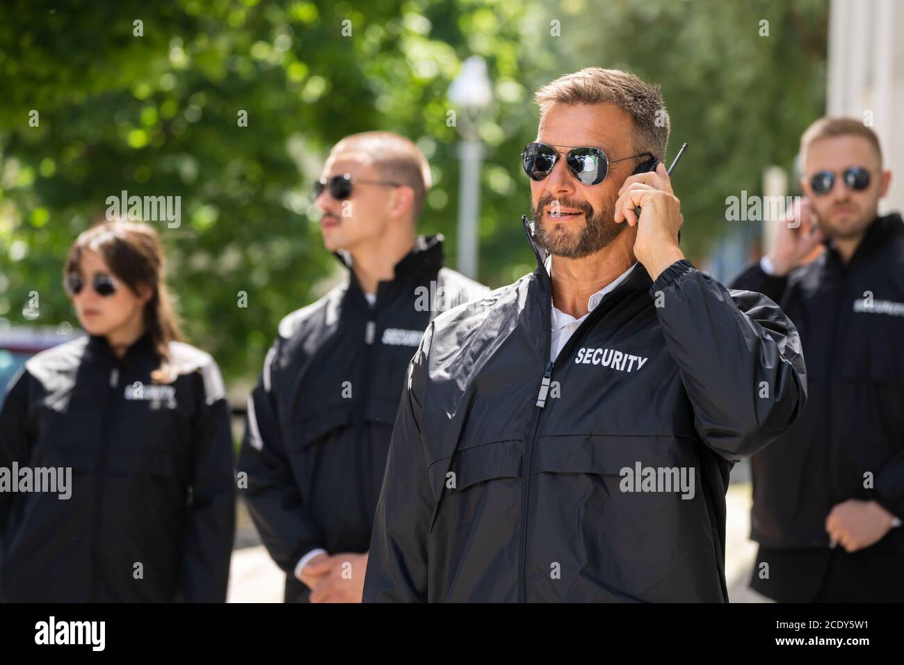 Security Guard Event Service. Officer And His Group Stock Photo - Alamy