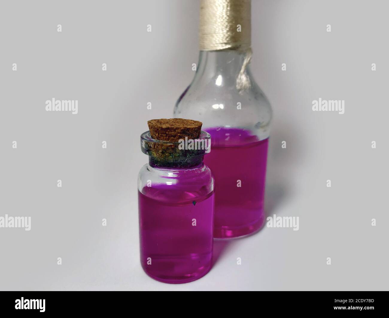 Potions with pink liquid. Alchemy set with flasks. small glass bottles ...