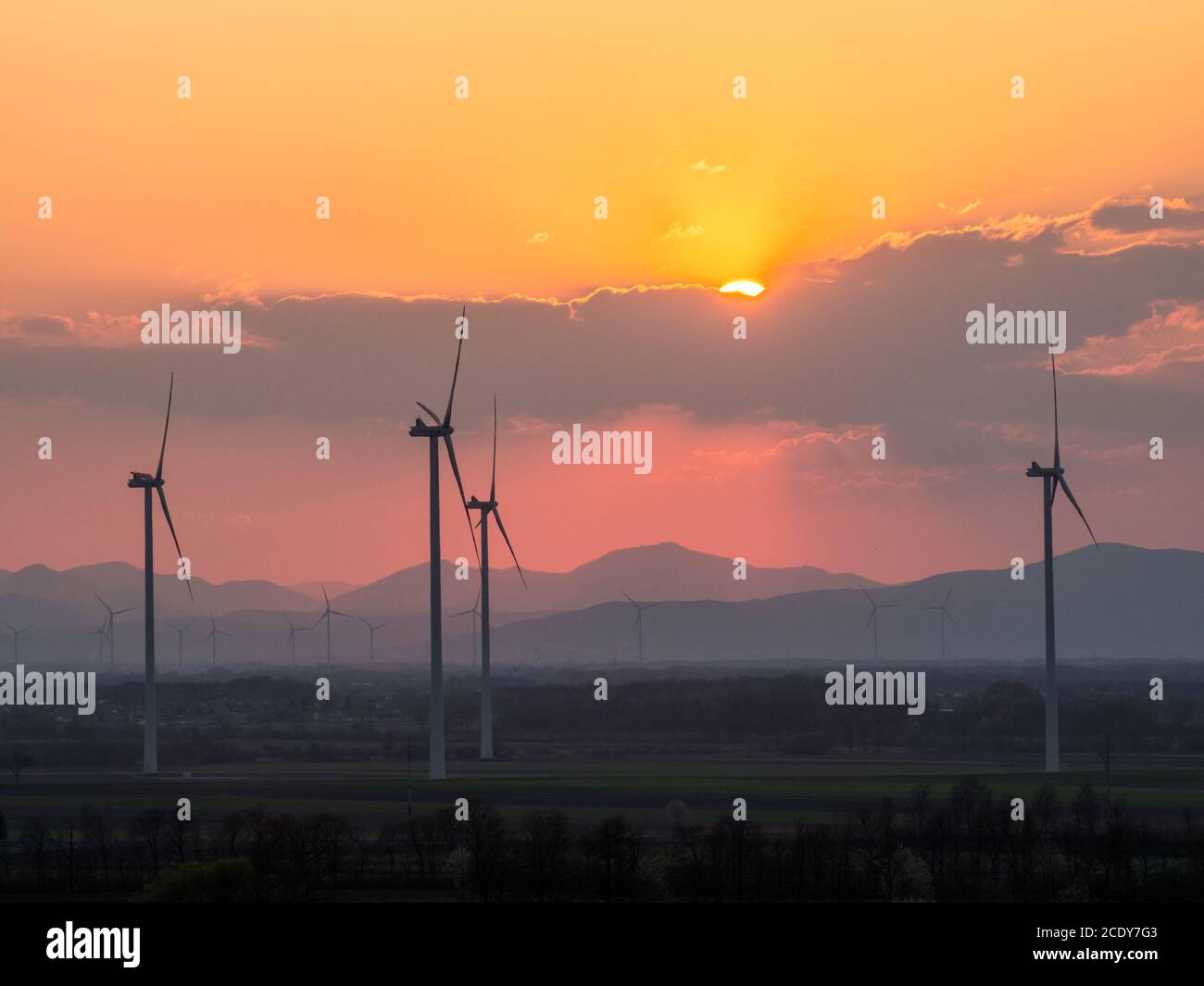 Windmill turbine for power generator at sunset Stock Photo - Alamy