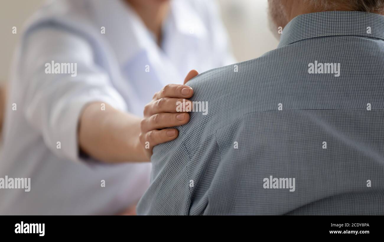 Close up caring doctor touching mature patient shoulder Stock Photo - Alamy