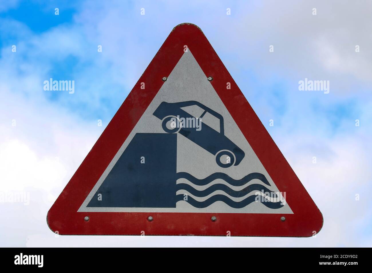 Driving danger warning sign at a coastal harbour wall Stock Photo - Alamy