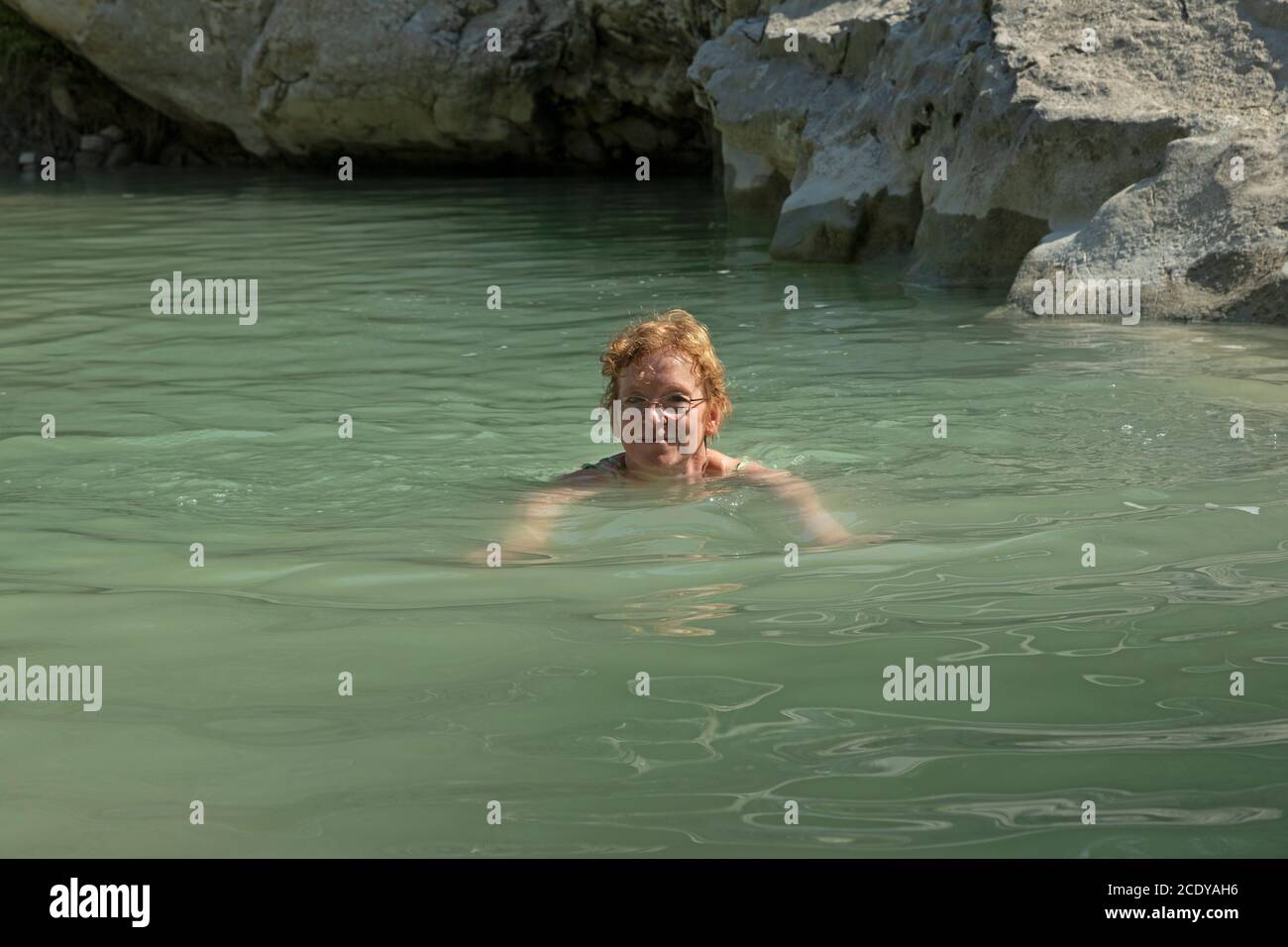 woman bathing in limestone basins, River Mirna, Kotli, Istria, Croatia ...