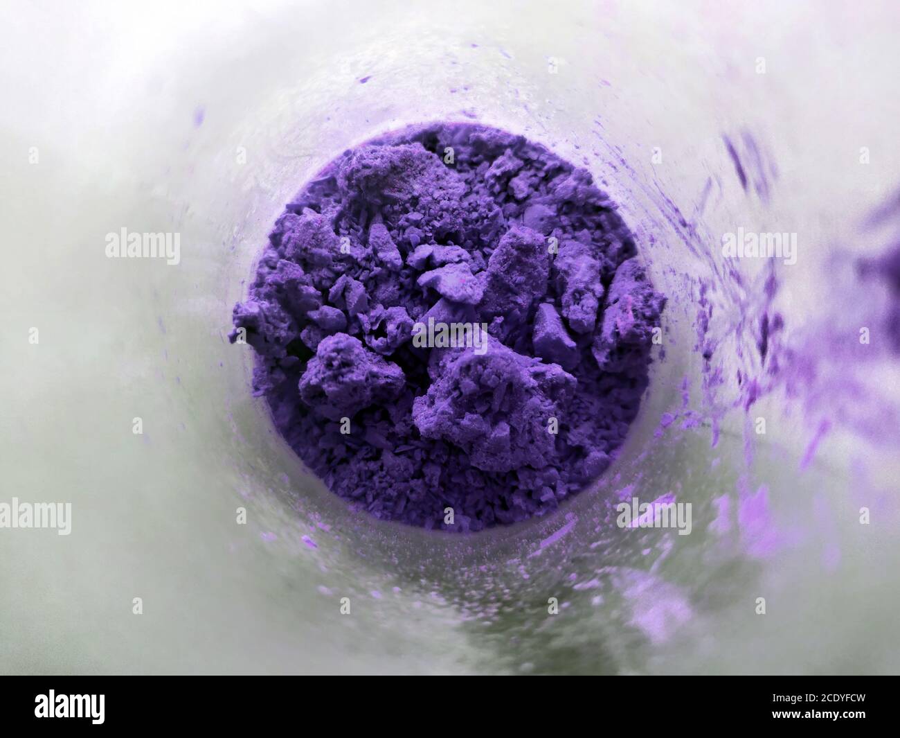 Violet powder in glass cup, bowl with ingredient close up. colored ...
