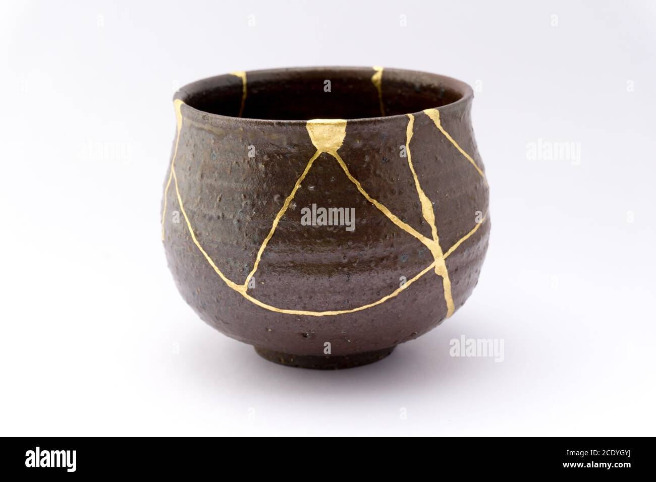 Kintsugi brown chawan. Gold cracks restoration on old Japanese ceramic ...