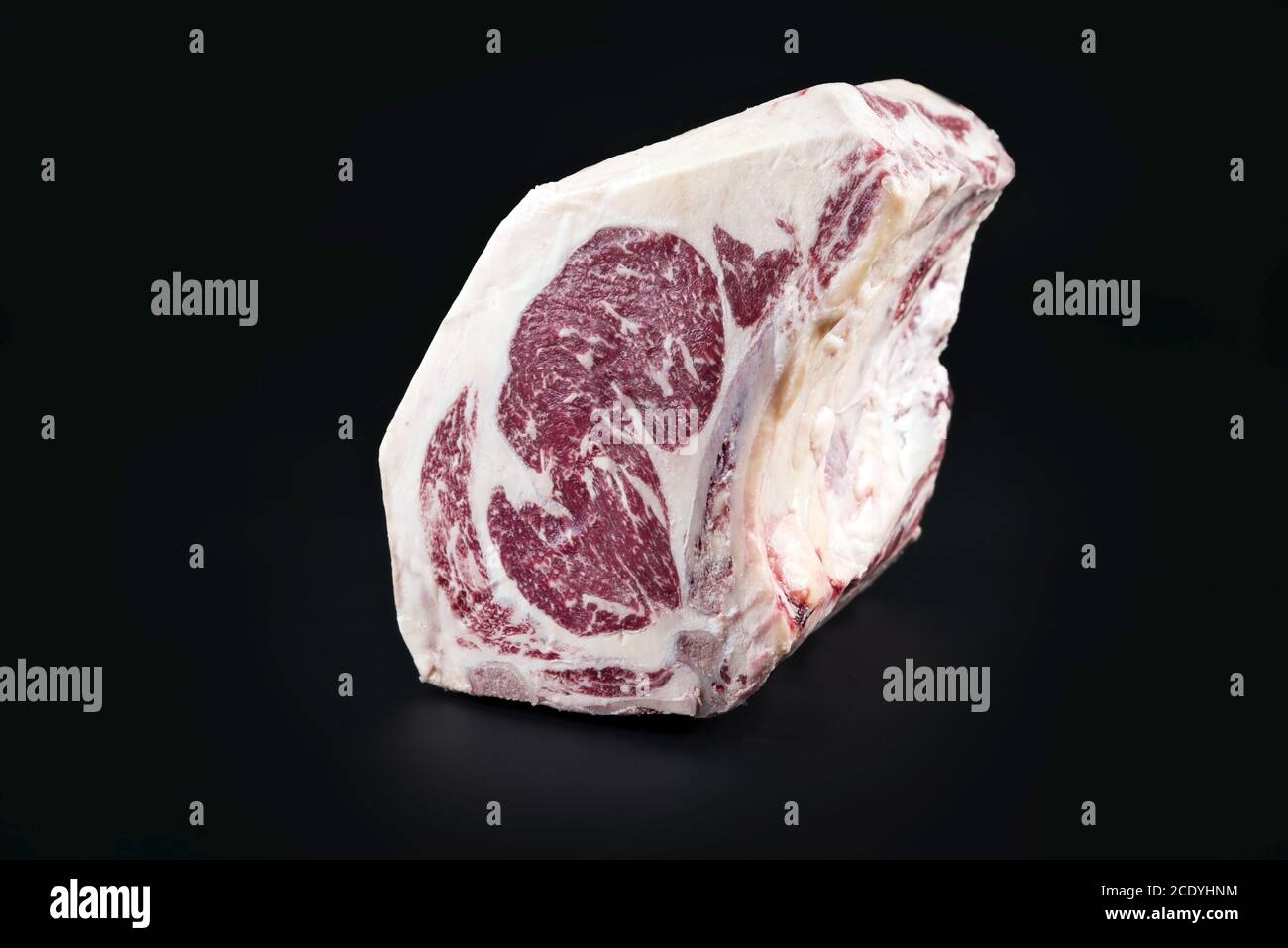 Raw dry aged wagyu cote de boeuf beef block as closeup on black ...