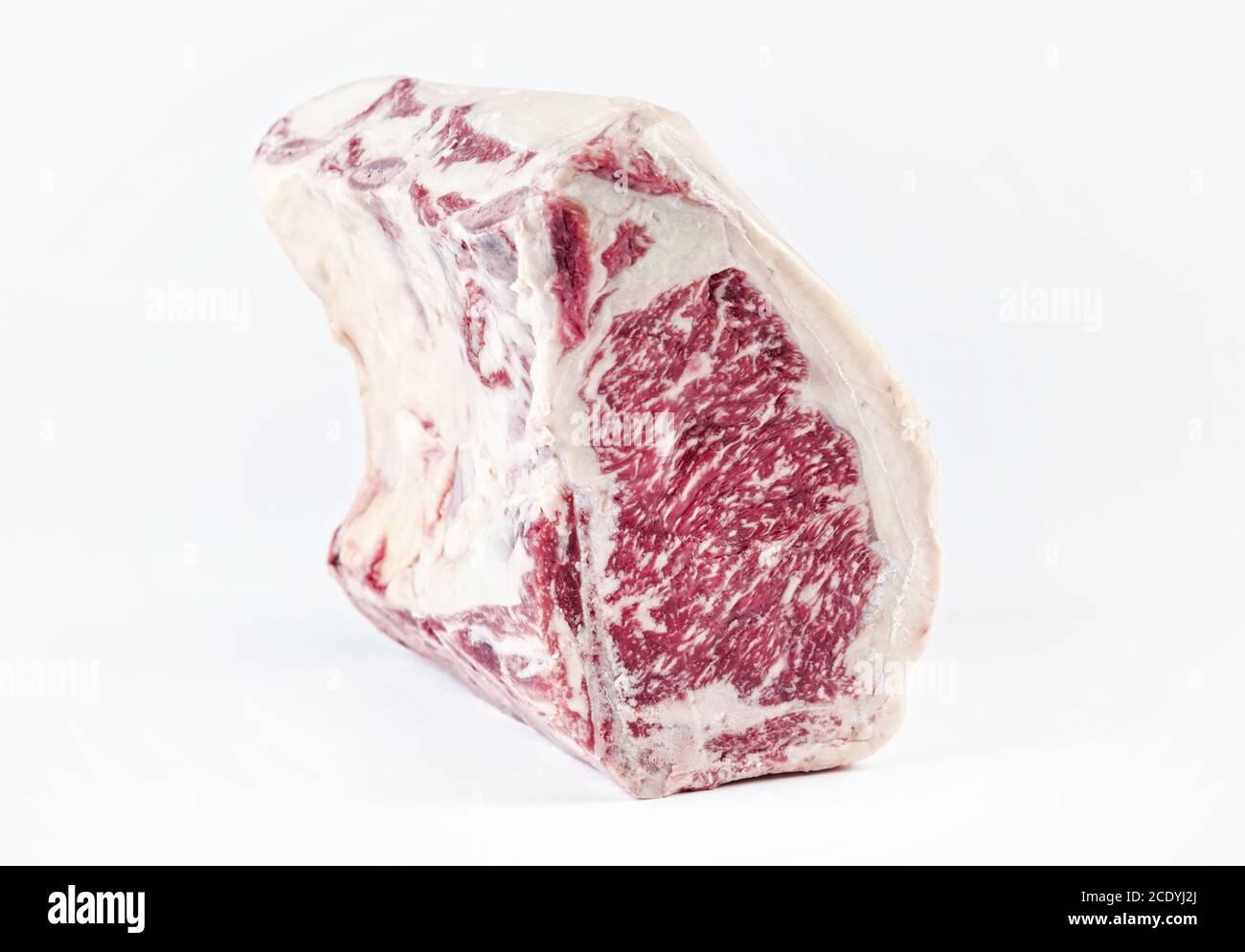 Raw dry aged wagyu cote de boeuf beef block as closeup on white ...