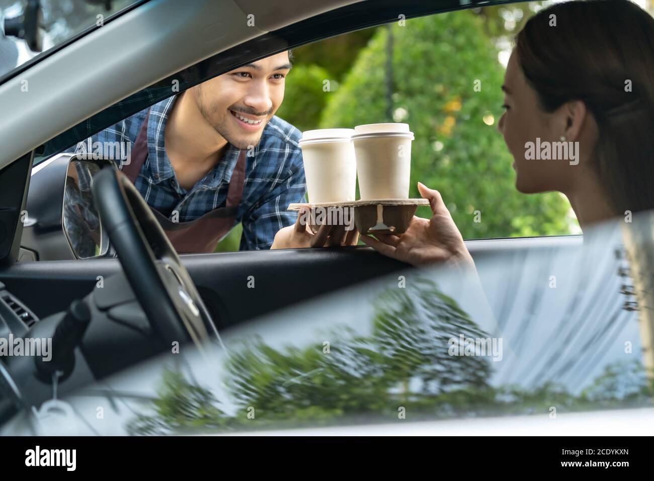 Waiter deliver food throght drive thru service Stock Photo - Alamy