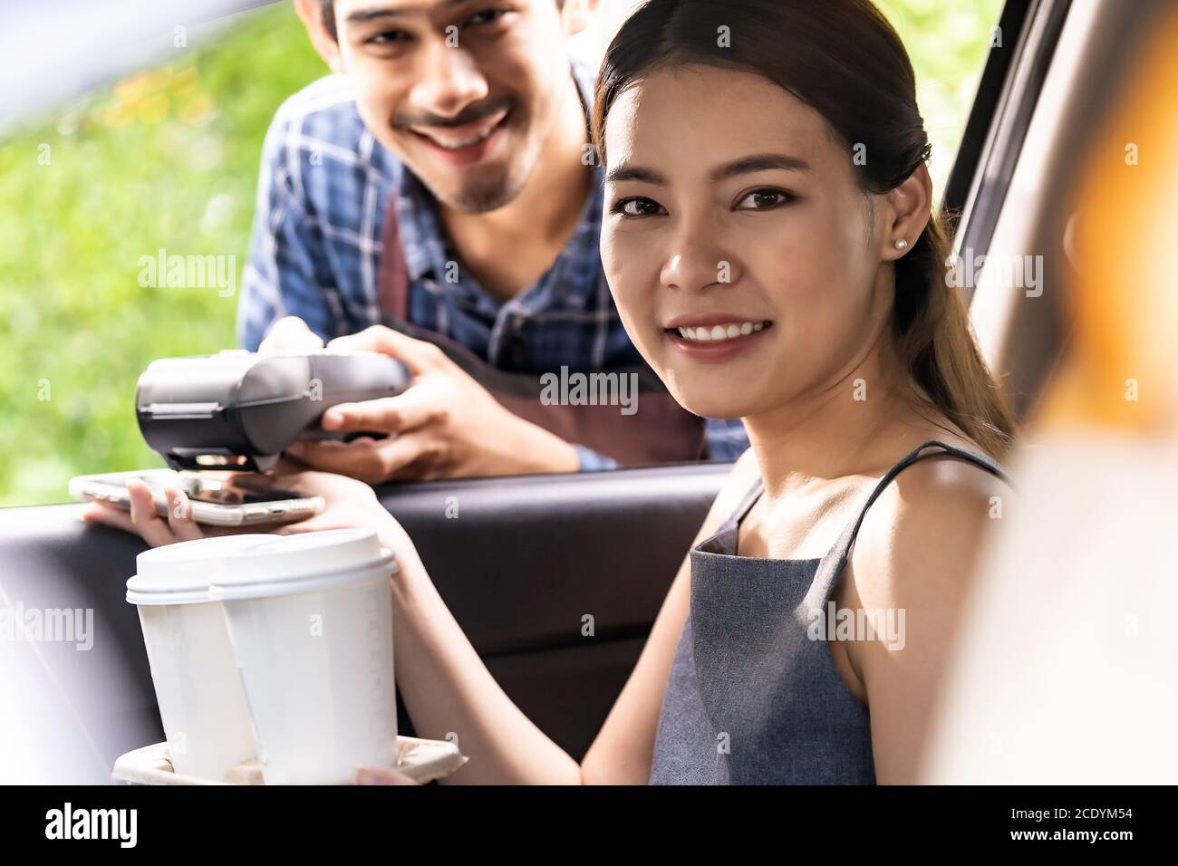 Asian customer make contactless mobile payment Drive thru Stock Photo ...