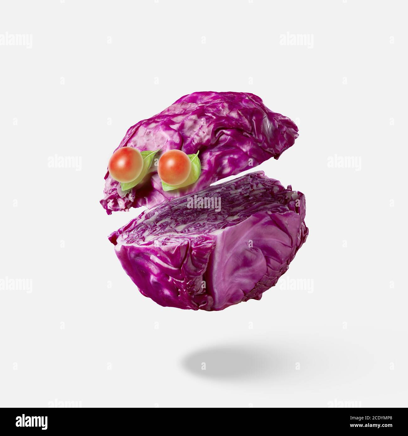 Cut red cabbage as a floating head with eyes from cherry tomatoes Stock ...