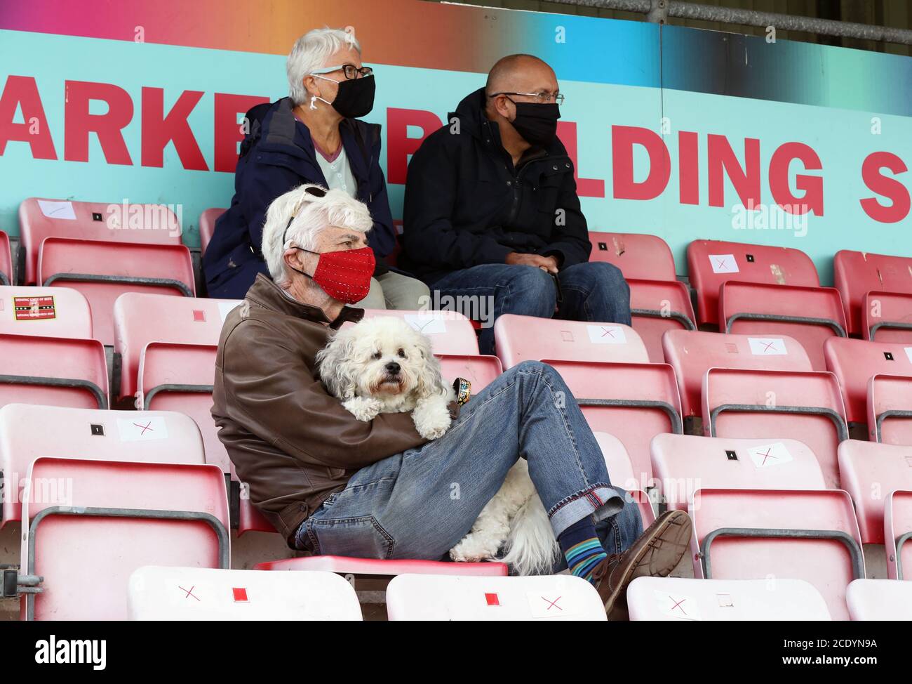 Socially distanced fans in the stands wearing masks during the pre ...