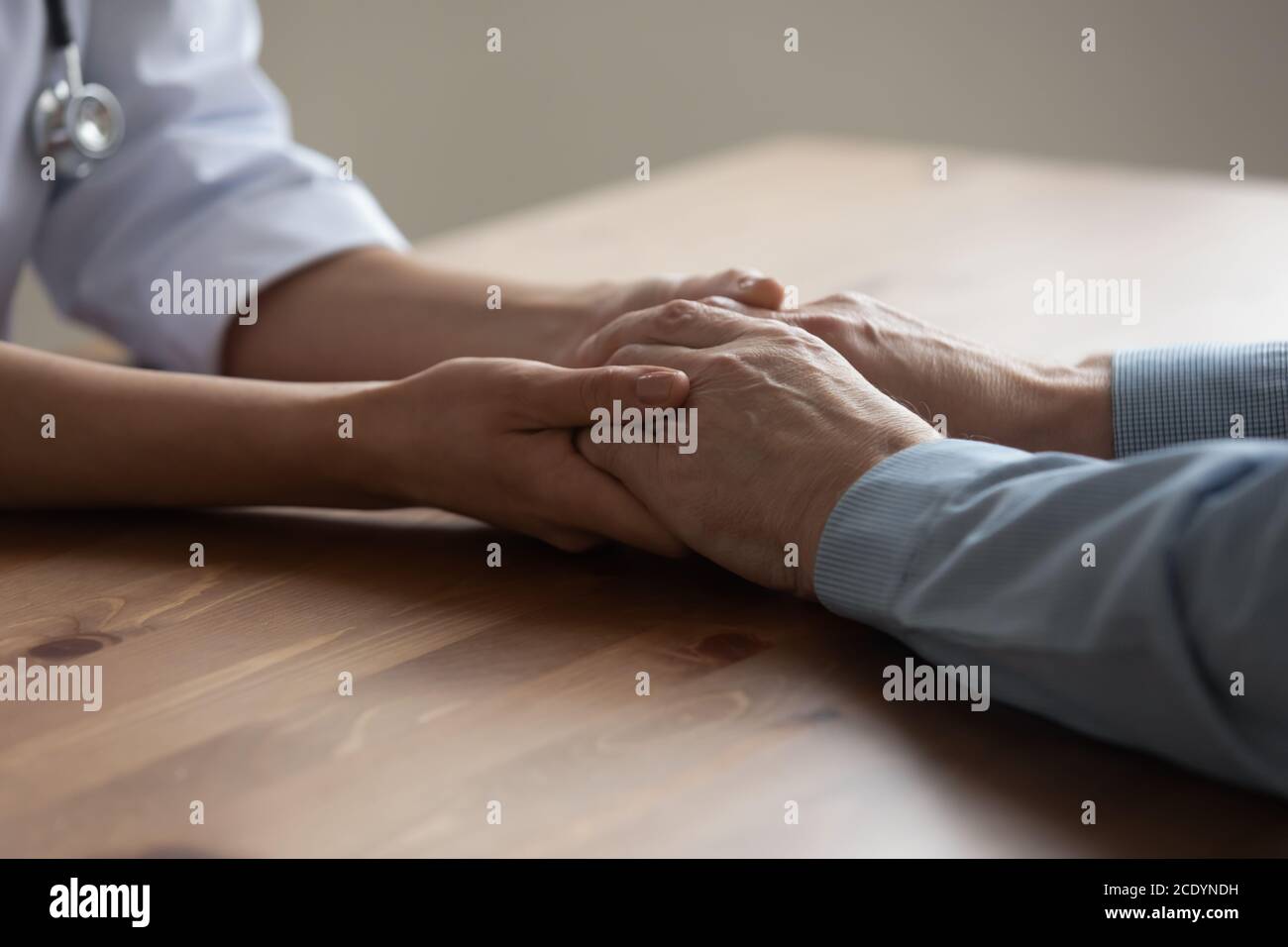 Close up caregiver comforting aged old patient, holding hands Stock ...