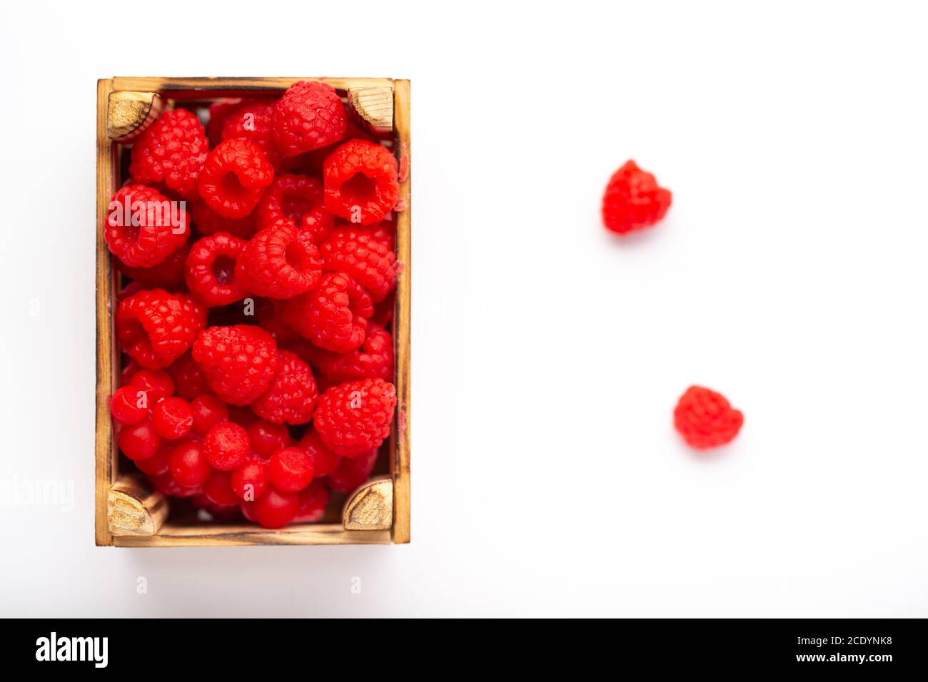 Some raspberries in a small wooden box Stock Photo - Alamy
