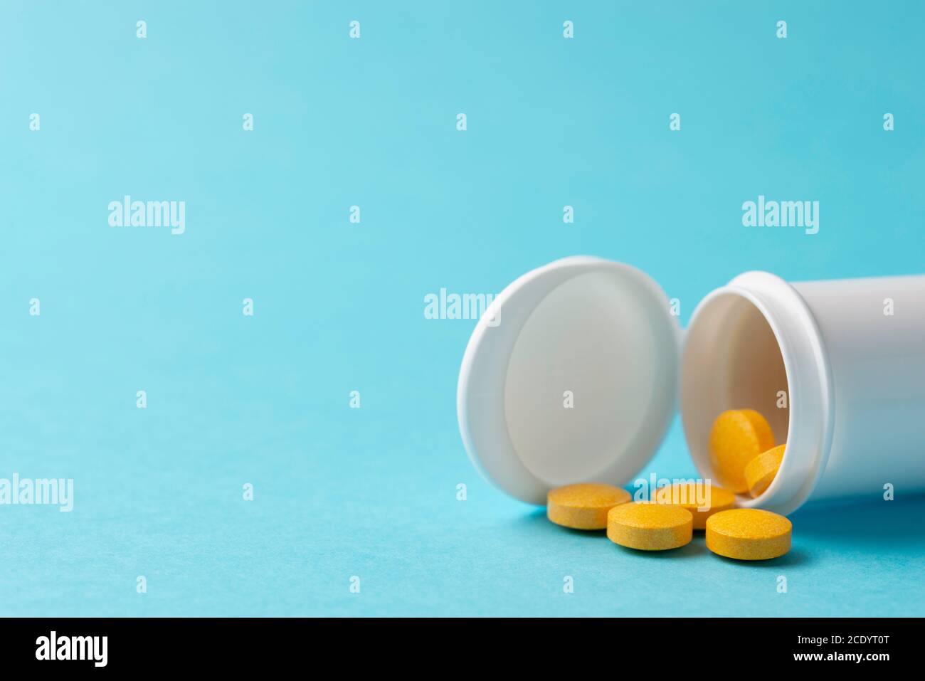 Medical container with various tablets on a blue background Stock Photo ...