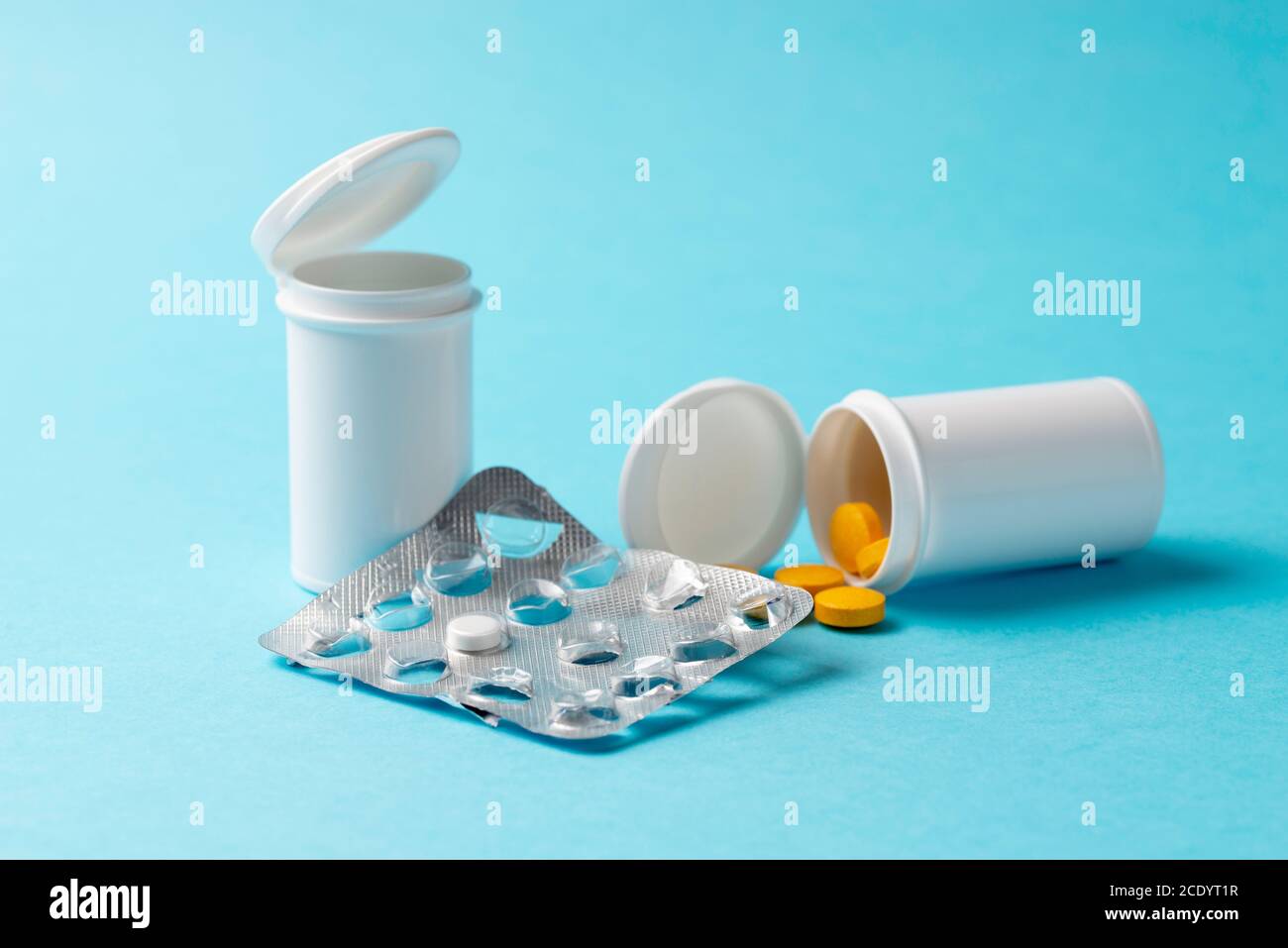 Medical containers with various tablets on a blue background Stock ...