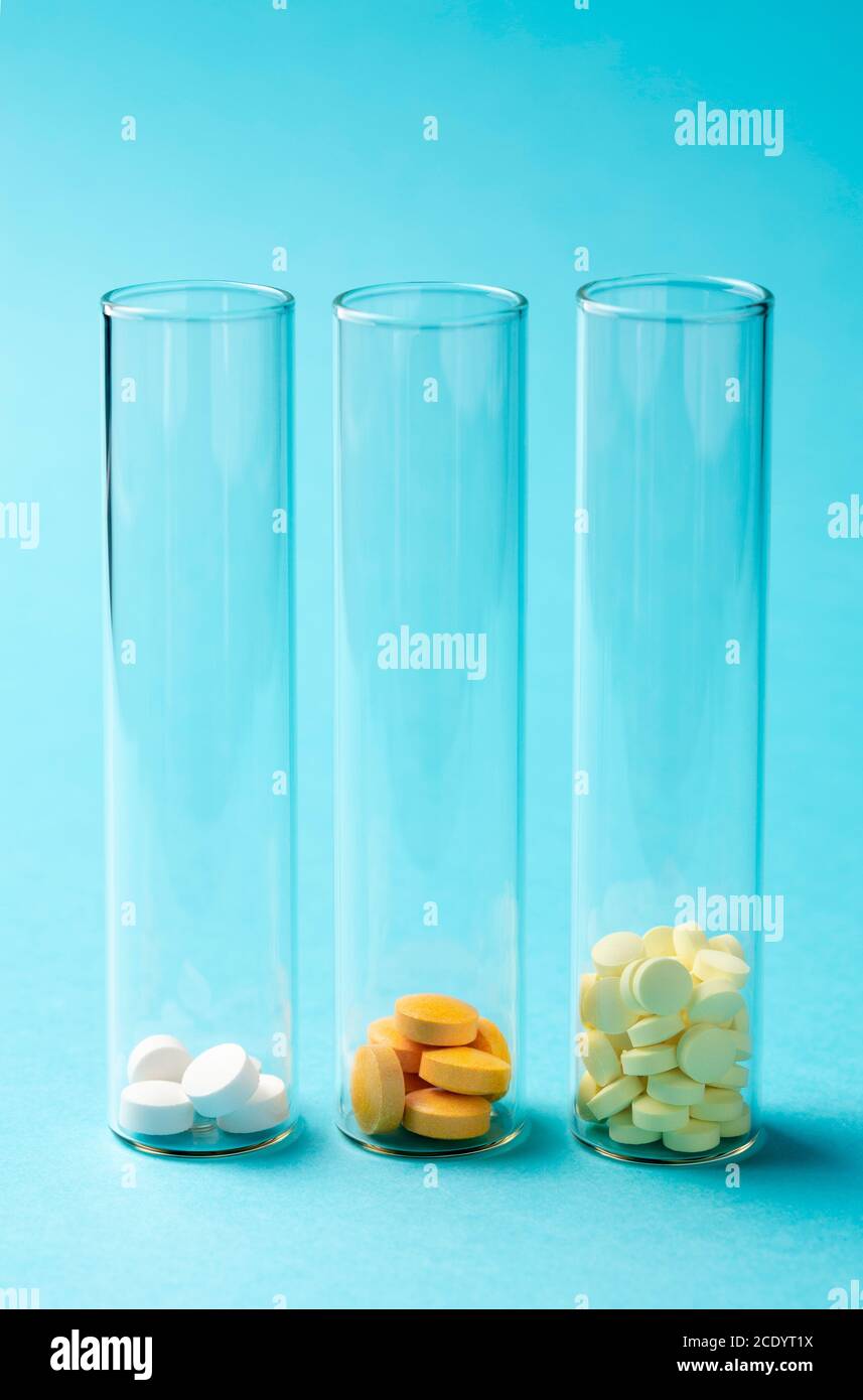 Medical containers with various tablets on a blue background Stock ...