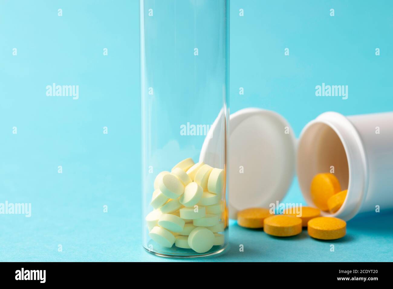 Medical containers with various tablets on a blue background Stock ...