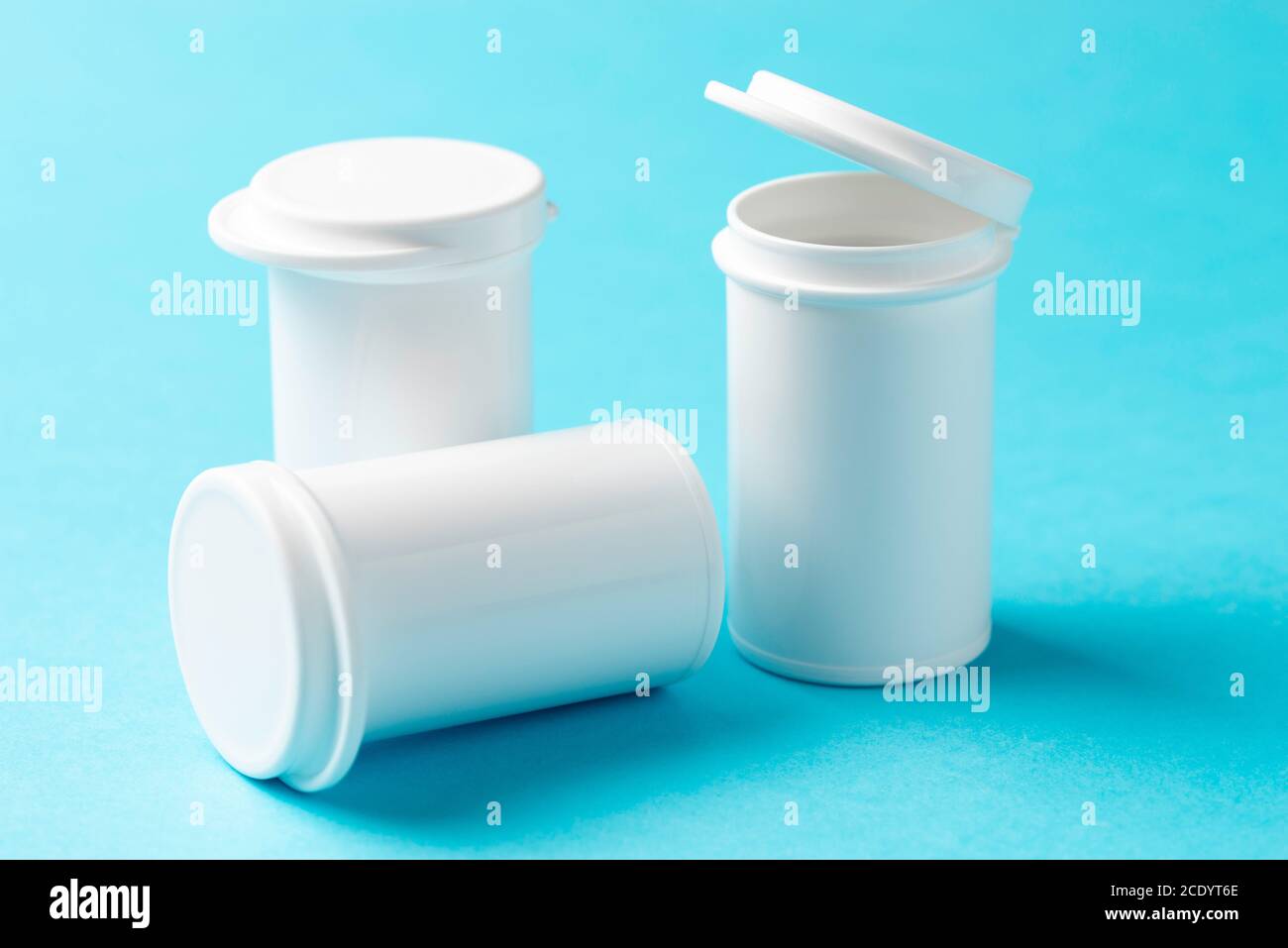 Medical containers on a blue background Stock Photo - Alamy