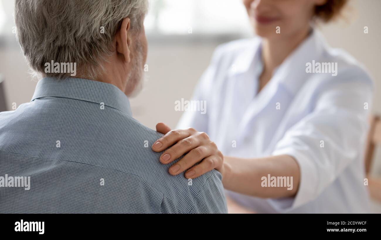 Close up woman doctor touching senior patient shoulder, comforting ...