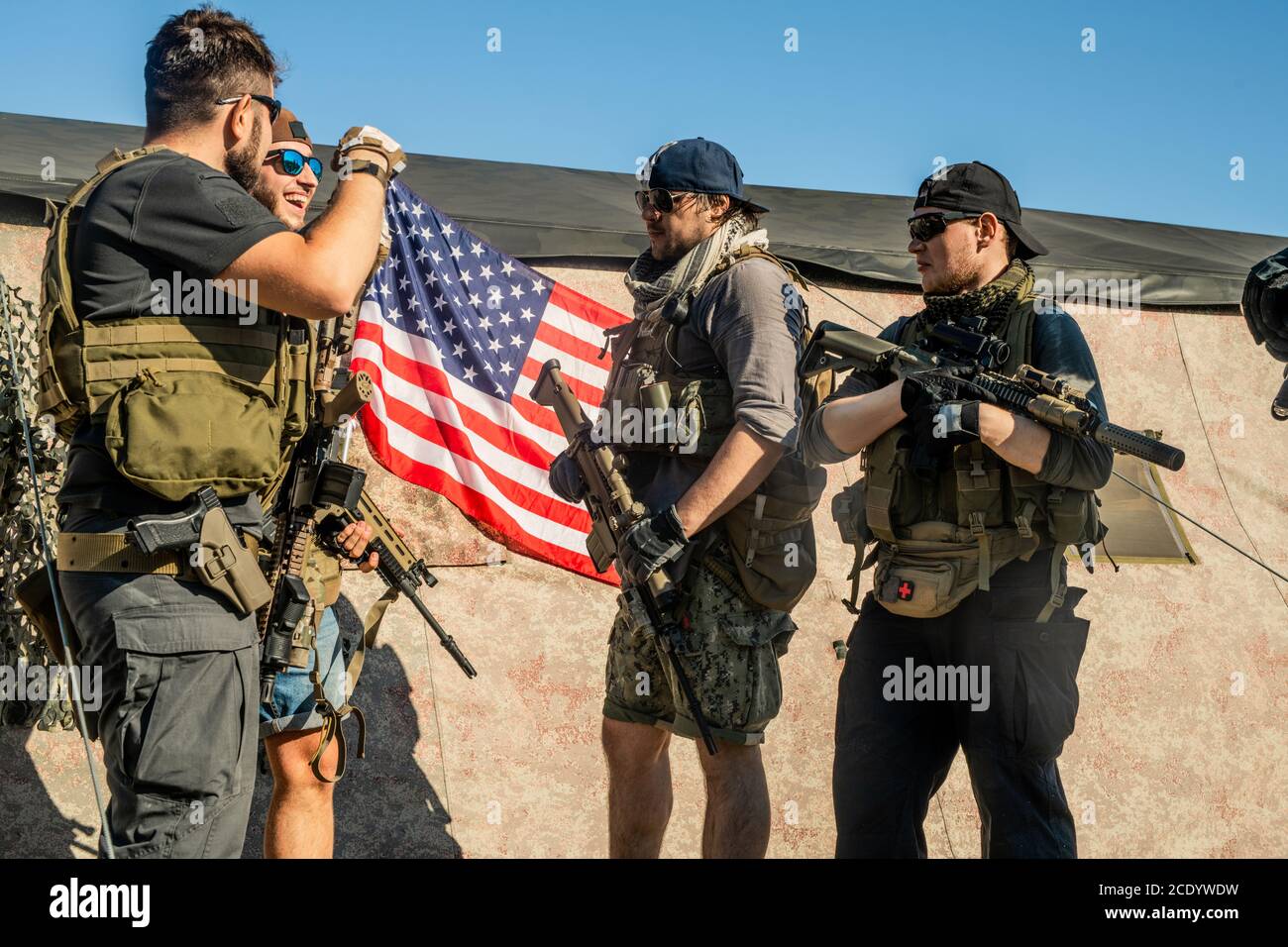 Professional shooters speaking cheerfully while giving advice to young ...
