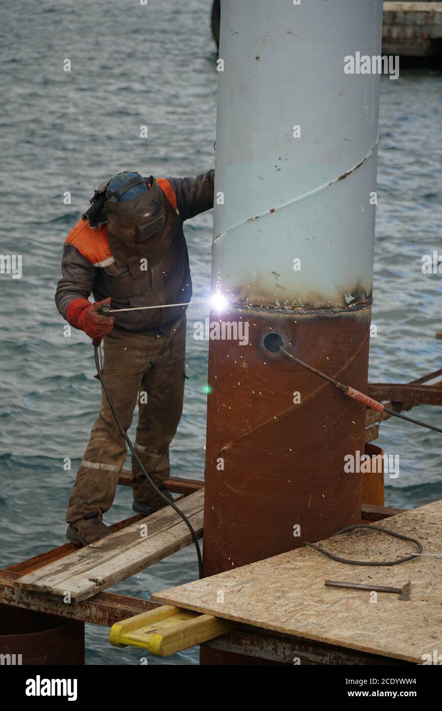 A welder is welding a steel pier pillar at outdoor Stock Photo - Alamy