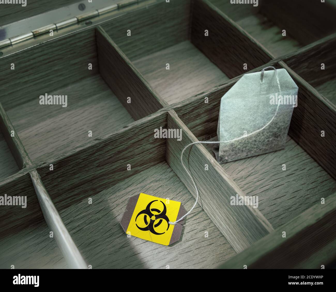 A poisoned tea bag in its wooden box. Biohazard symbol Stock Photo - Alamy