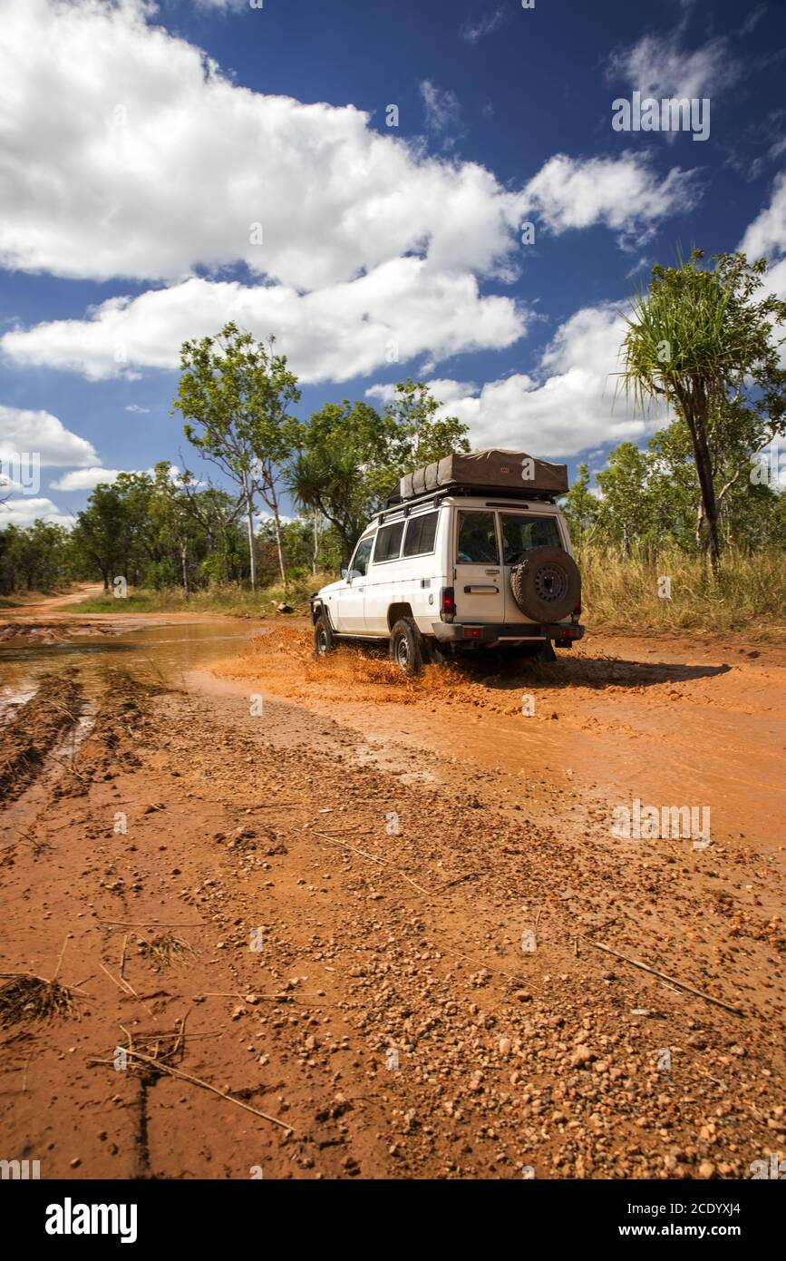 Western Australia – Flooded Outback gravel road with 4WD car crossing ...