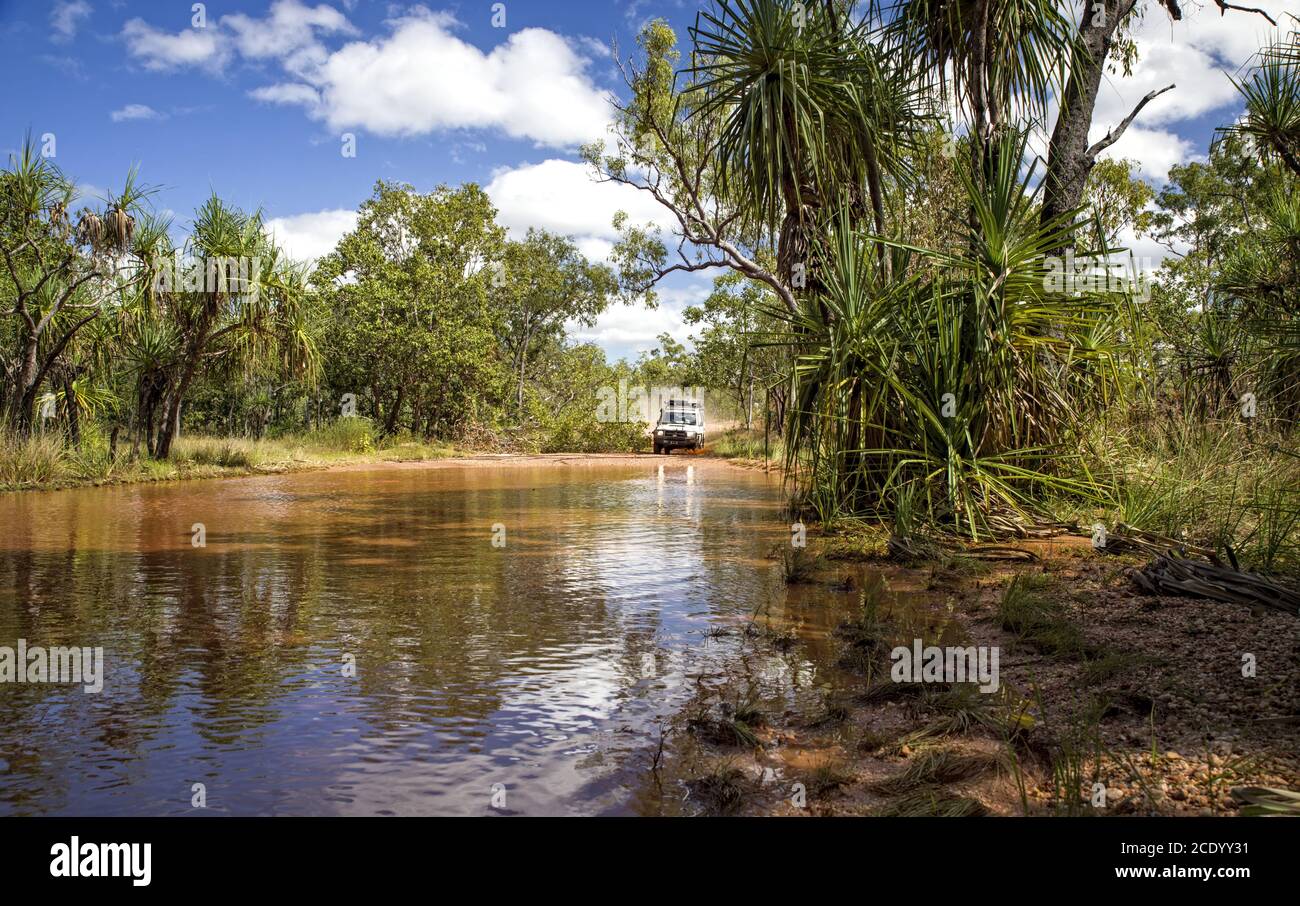 Western Australia – Flooded Outback gravel road with 4WD car crossing ...